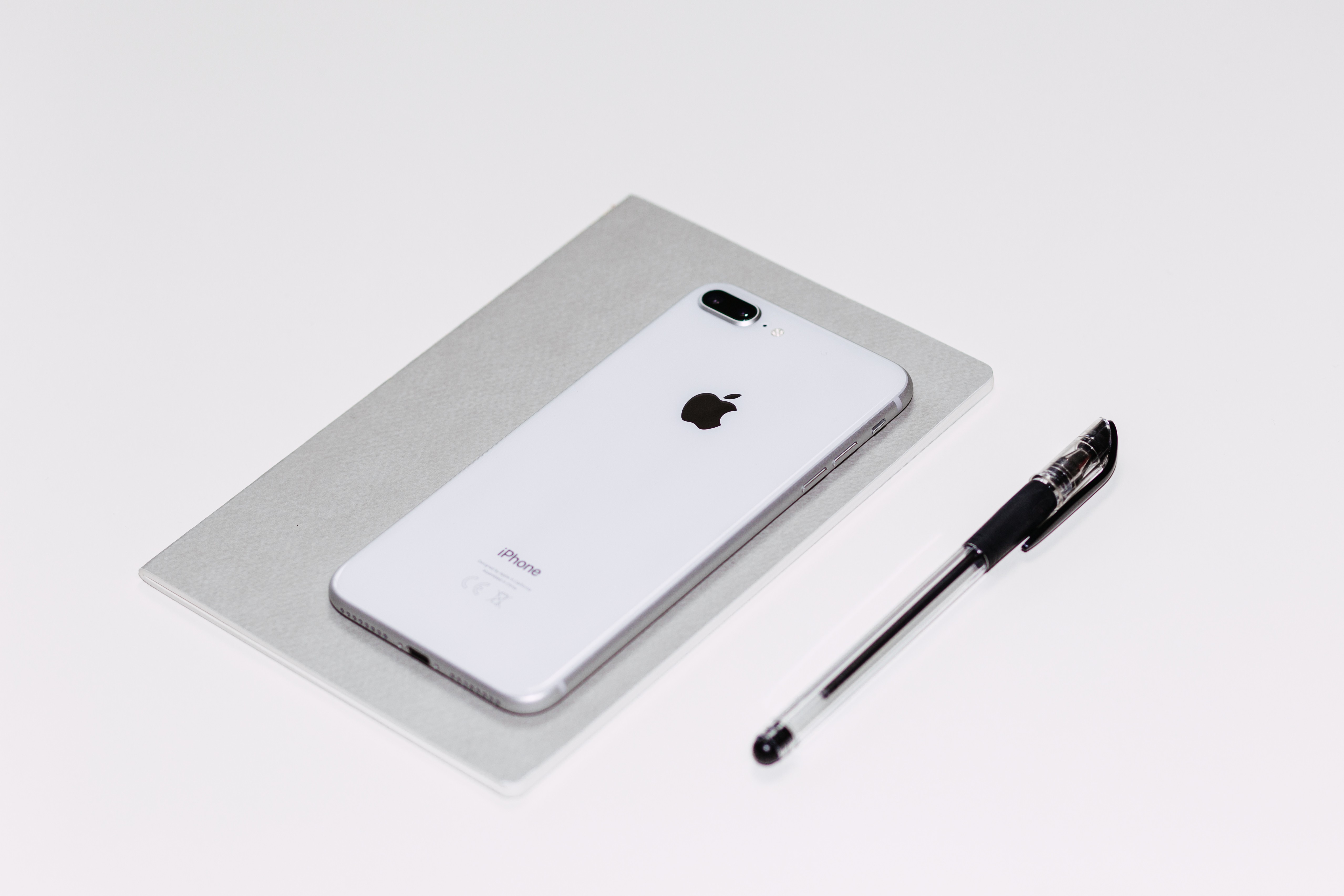 iPhone 8 Plus and a notebook - freestocks.org - Free stock photo